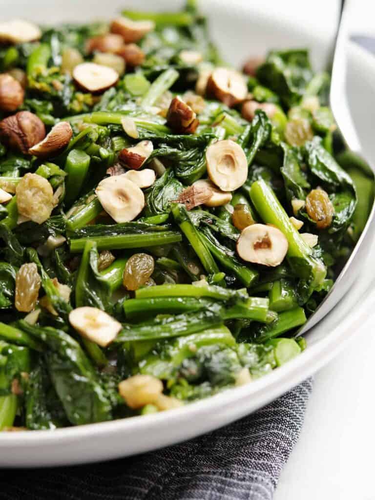 Rapini (Broccoli Rabe) with Raisins and Hazelnuts - Pinch and Swirl